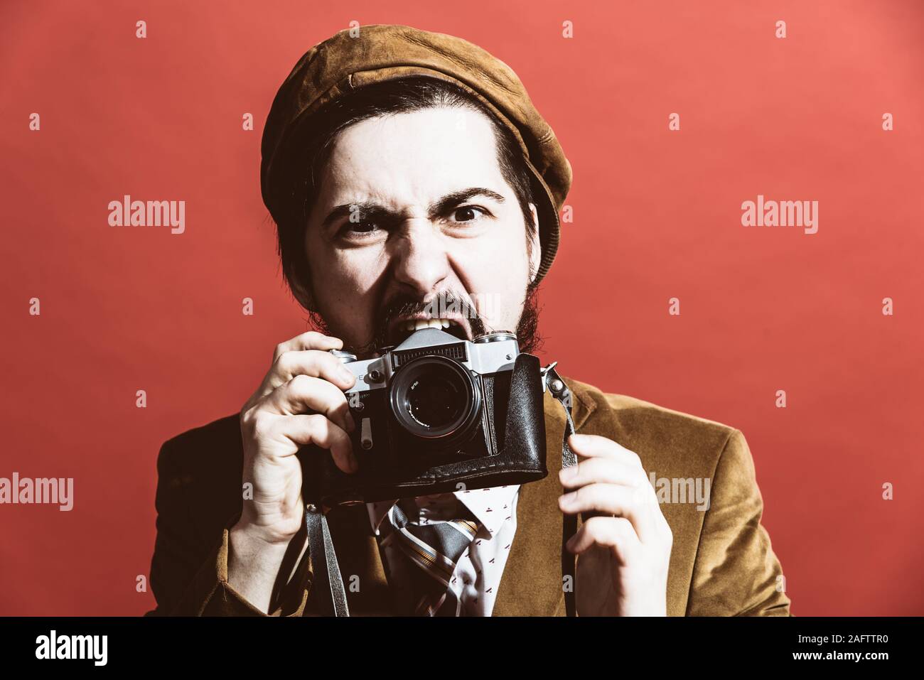 very positive photographer posing in studio with camera Stock Photo - Alamy