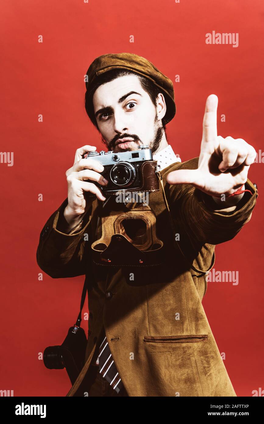 very positive photographer posing in studio with camera Stock Photo - Alamy