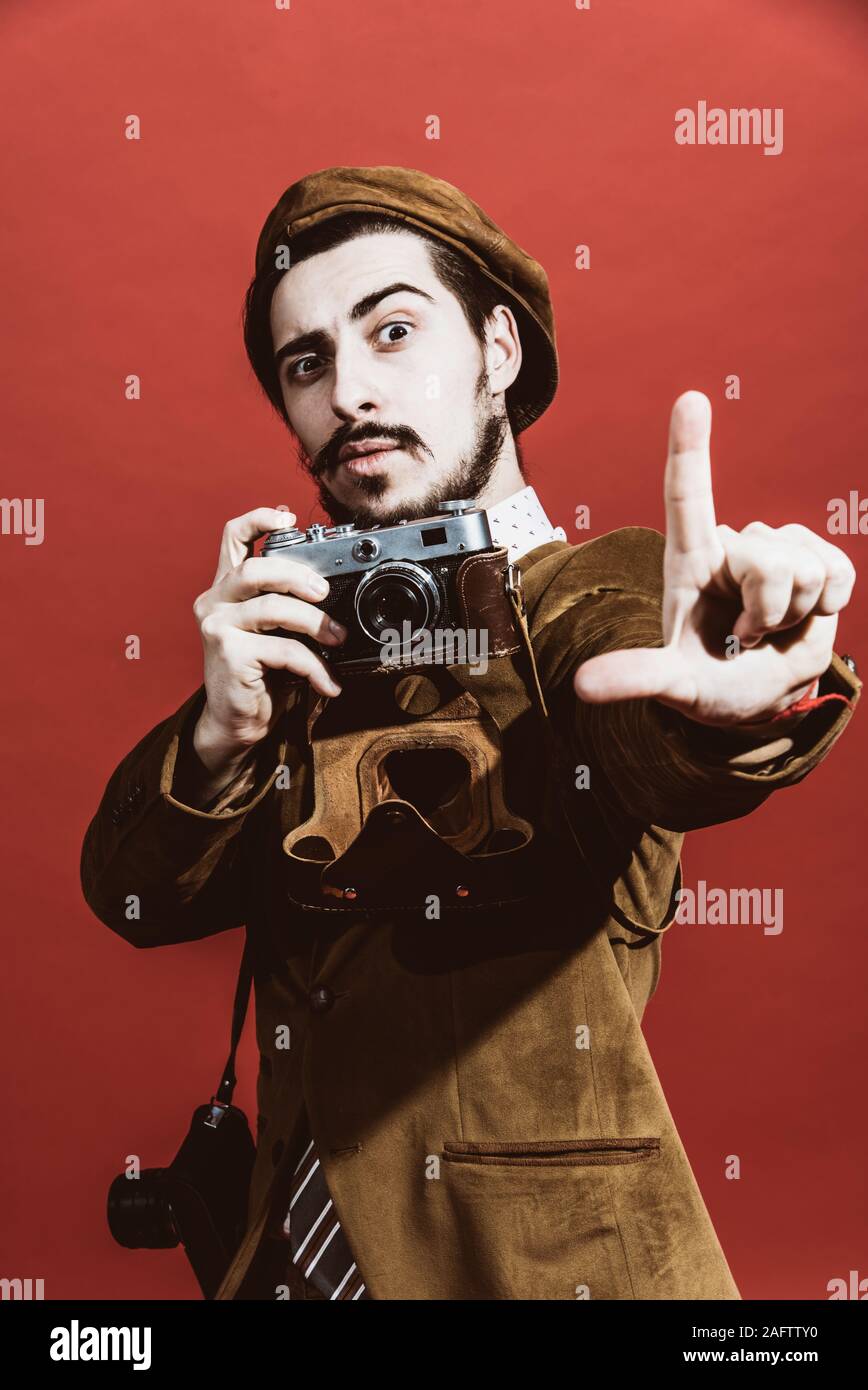 very positive photographer posing in studio with camera Stock Photo - Alamy