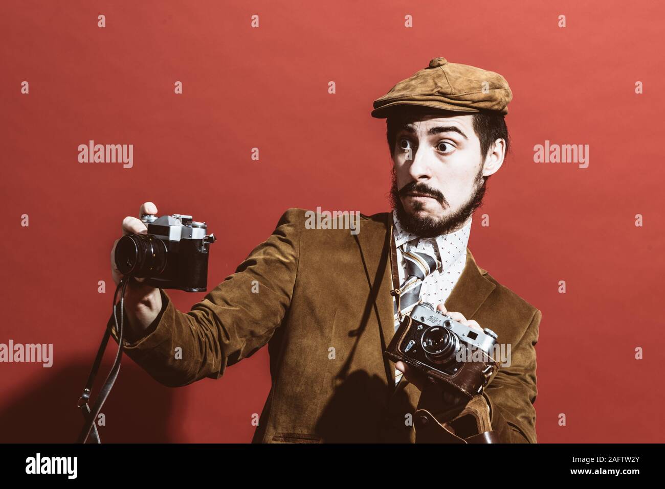 very positive photographer posing in studio with camera Stock Photo - Alamy