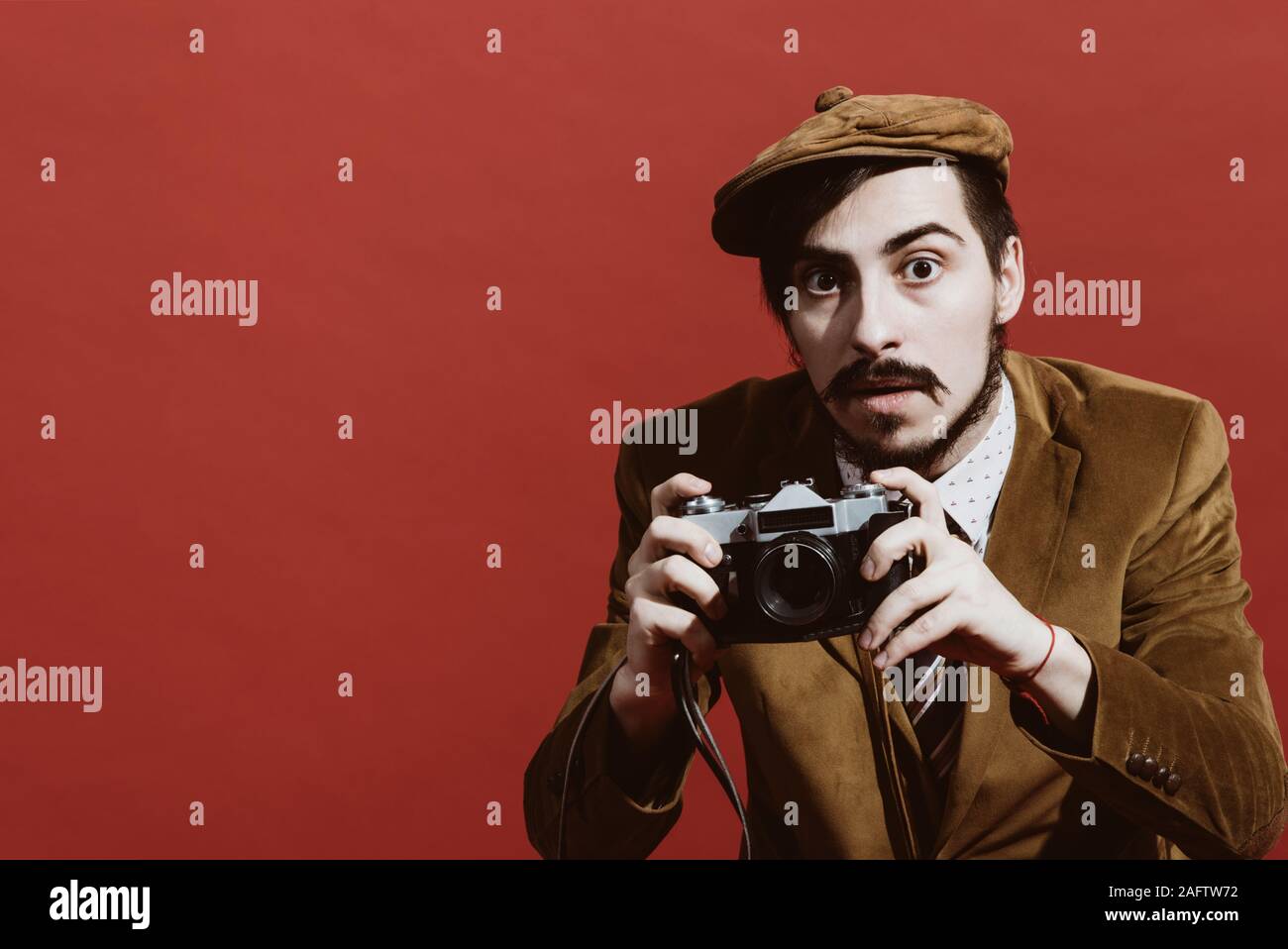 very positive photographer posing in studio with camera Stock Photo - Alamy