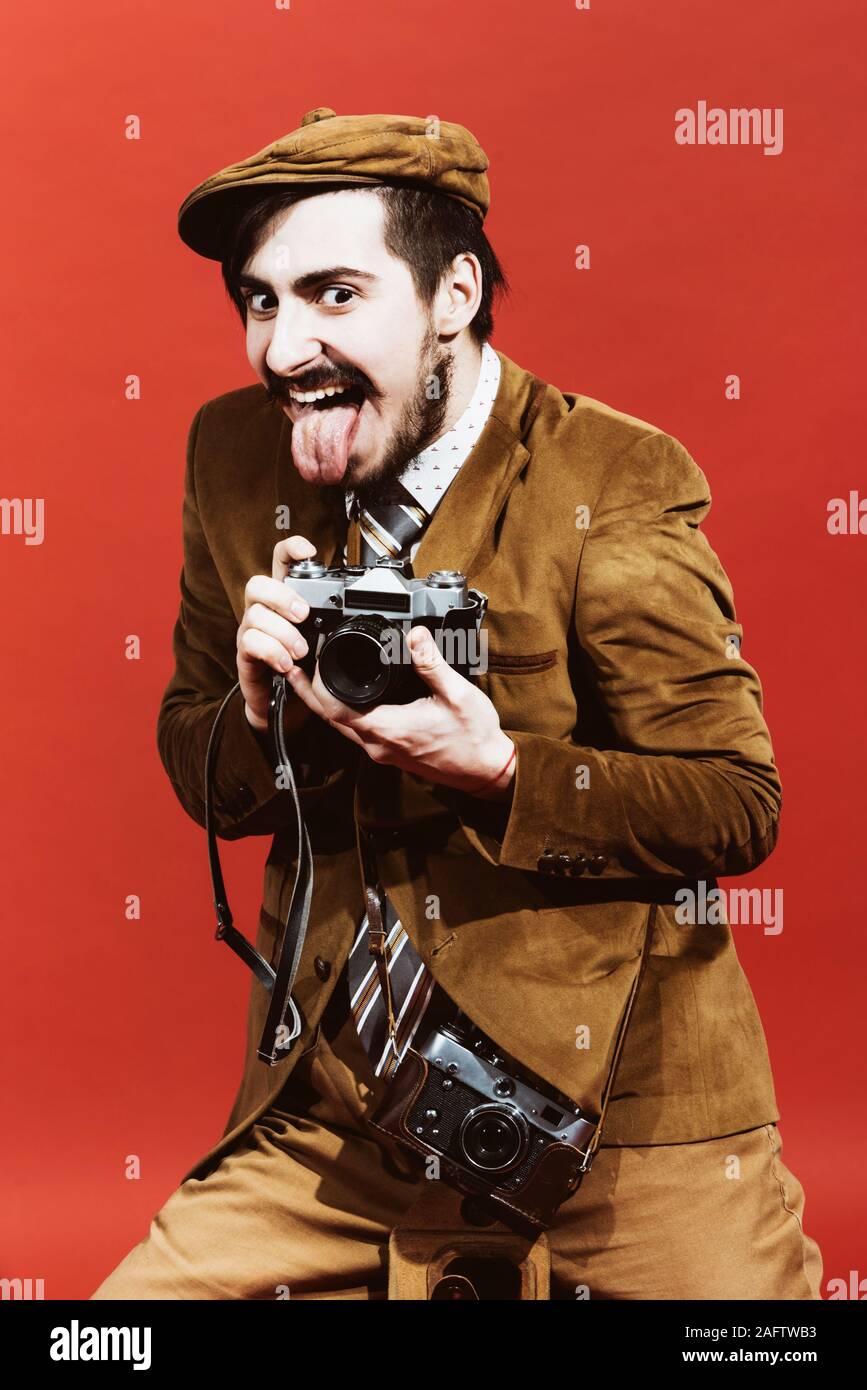 very positive photographer posing in studio with camera Stock Photo - Alamy