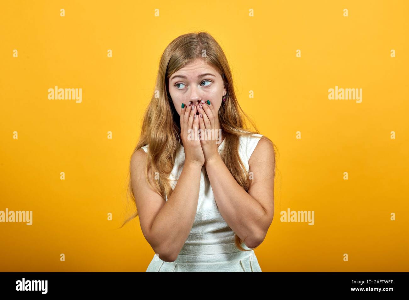 Scared young woman covering mouth with hands, looking frightened Stock ...