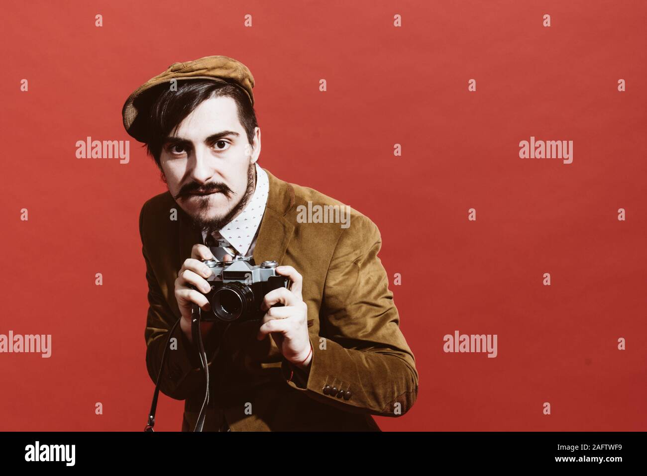 very positive photographer posing in studio with camera Stock Photo - Alamy