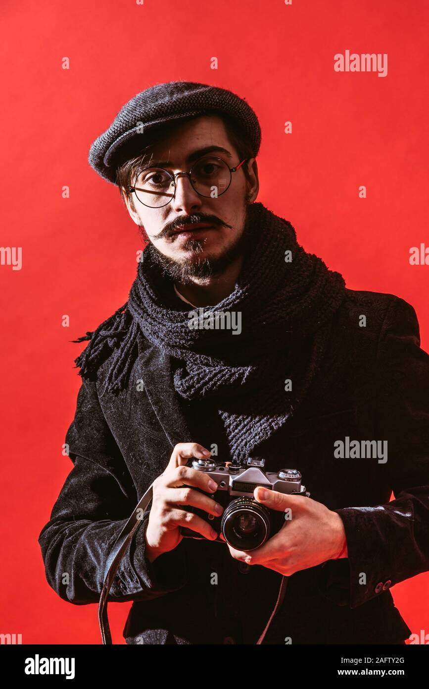 creative photographer posing in studio with camera in hands Stock Photo ...