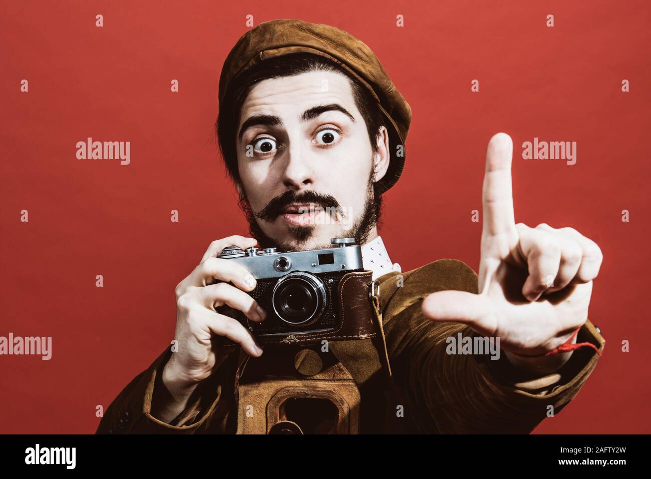 very positive photographer posing in studio with camera Stock Photo - Alamy