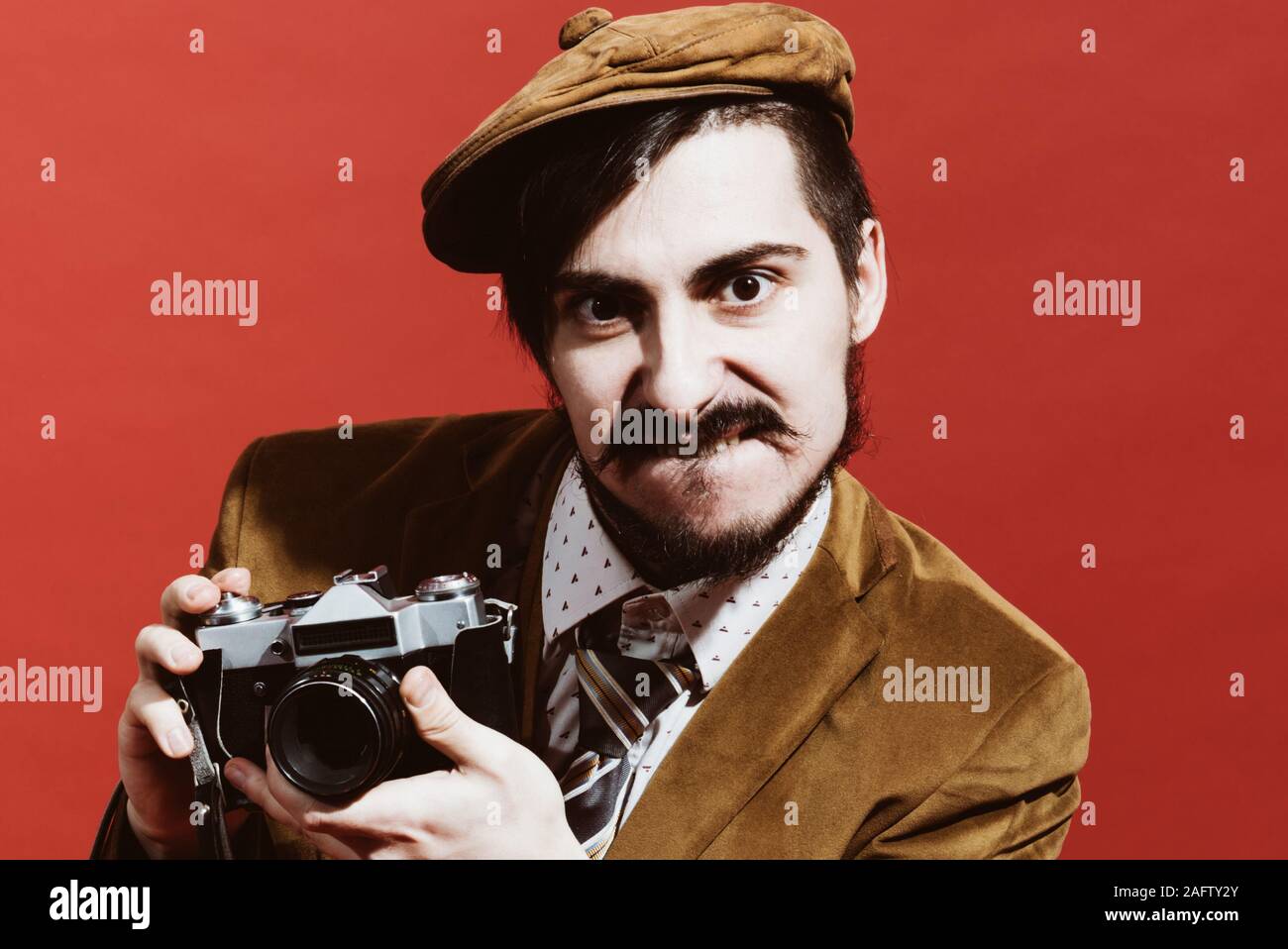 very positive photographer posing in studio with camera Stock Photo - Alamy