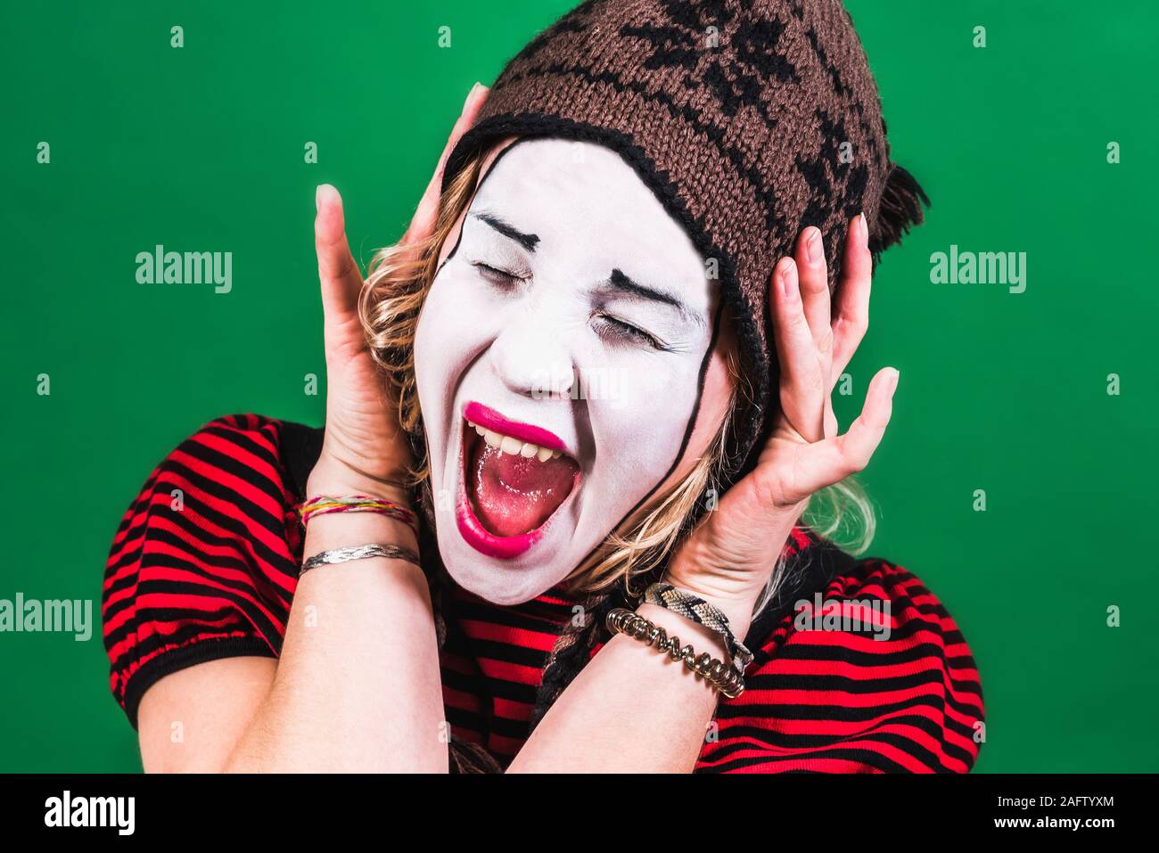 cheerful mime girl posing and grimacing in photo studio Stock Photo - Alamy