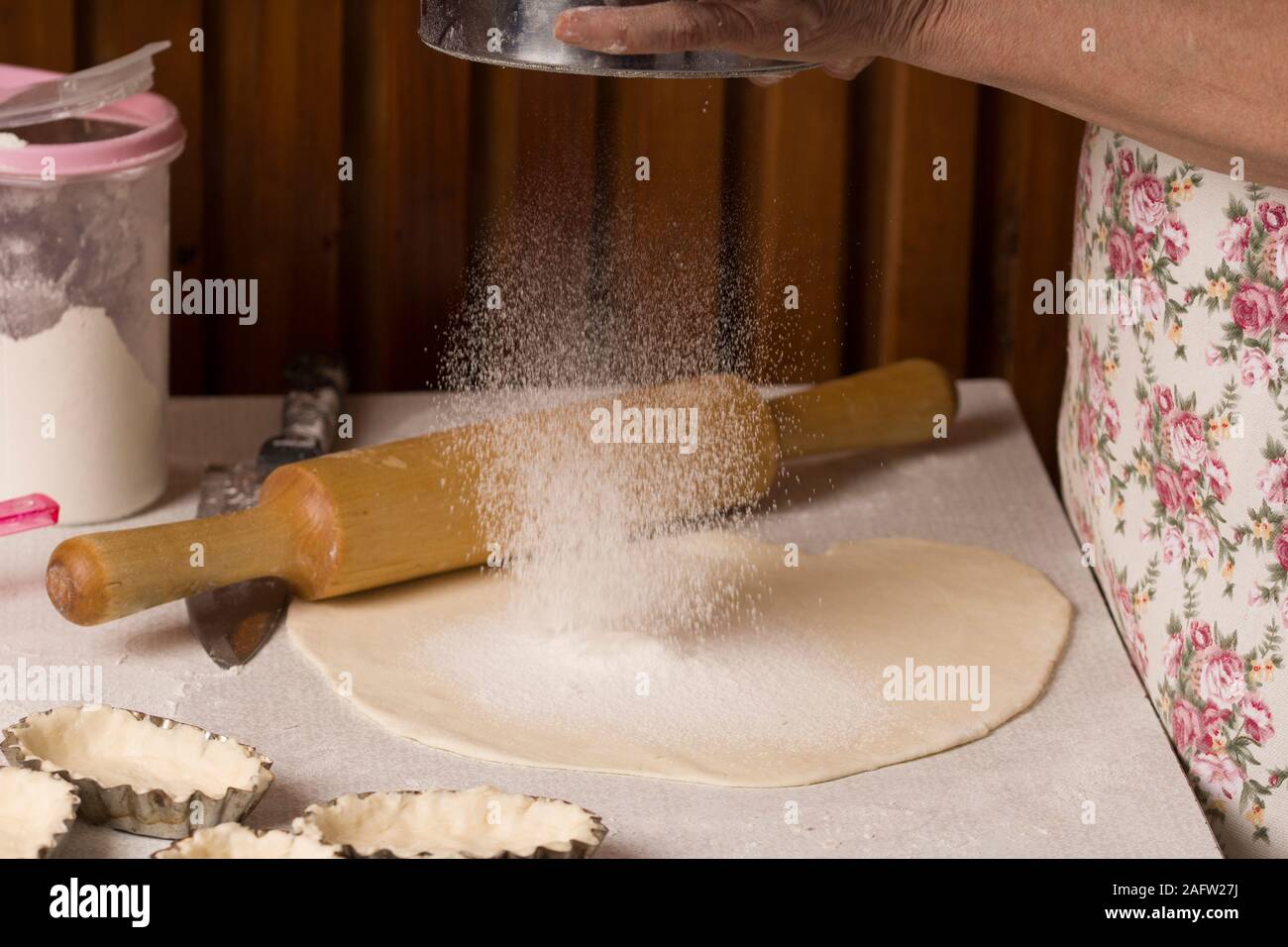 Preparation of bread dough. Bakery, flour is poured, flying flour ...