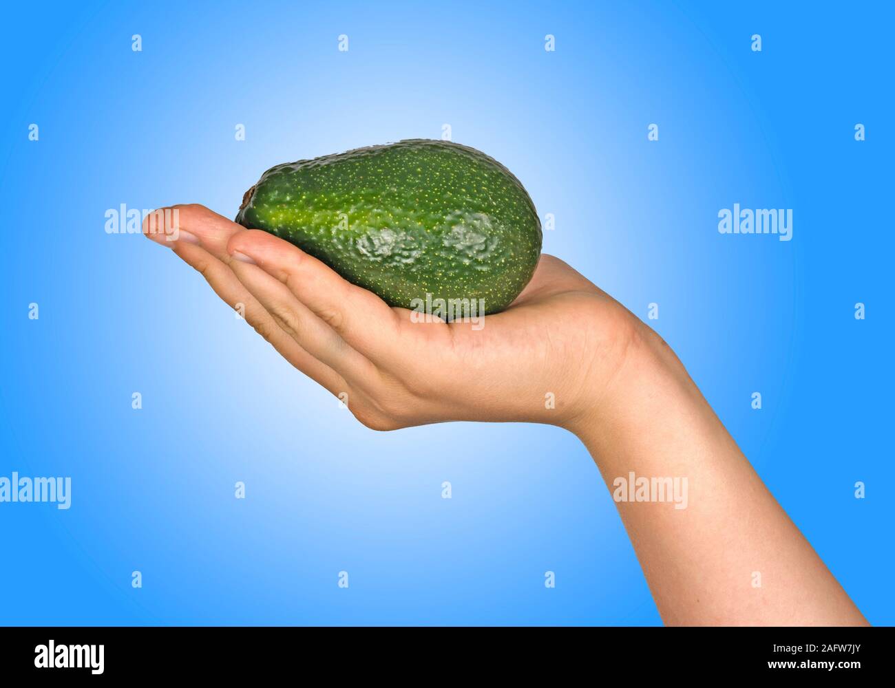 Hand with avocado Stock Photo - Alamy
