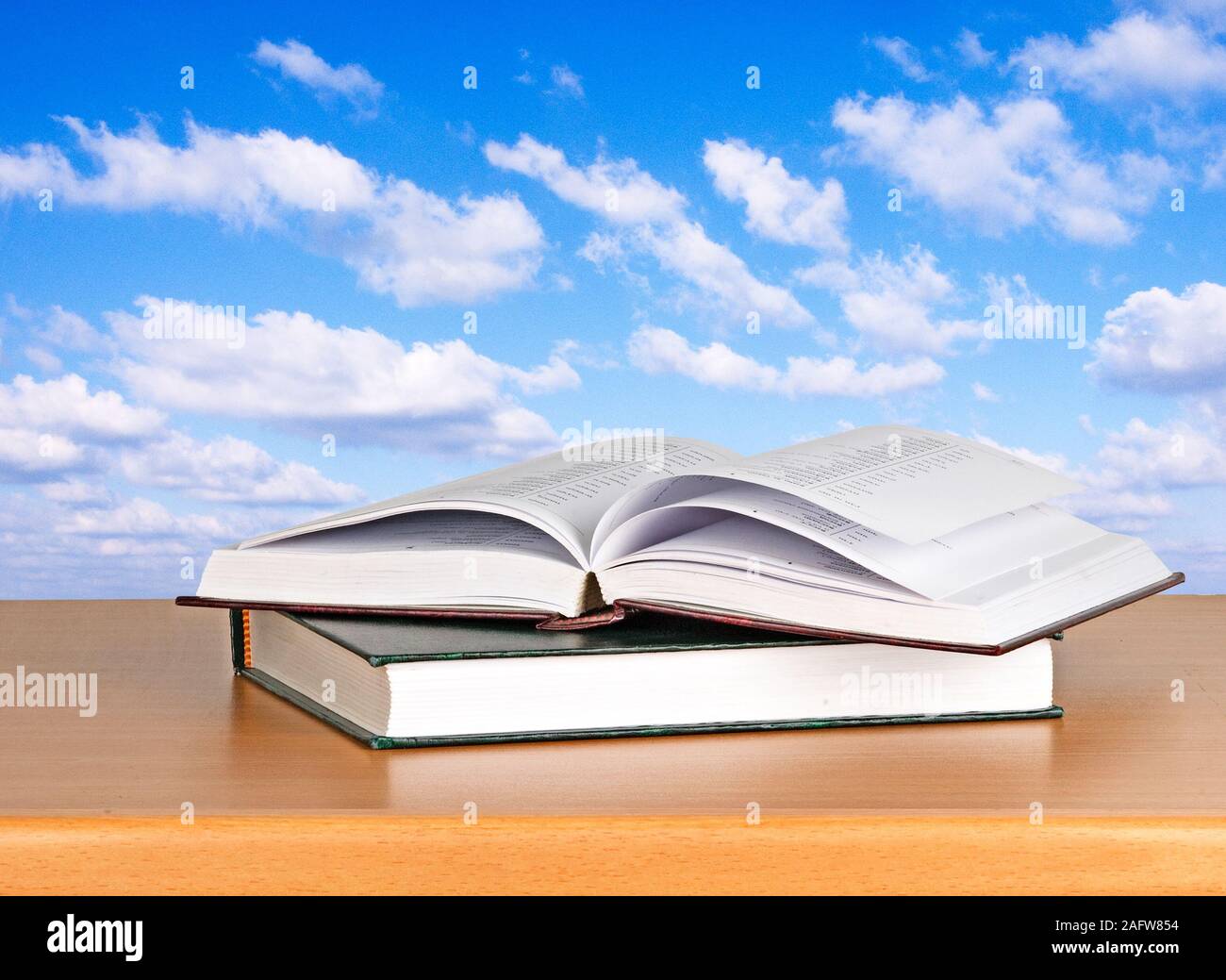 Open book on desk Stock Photo - Alamy