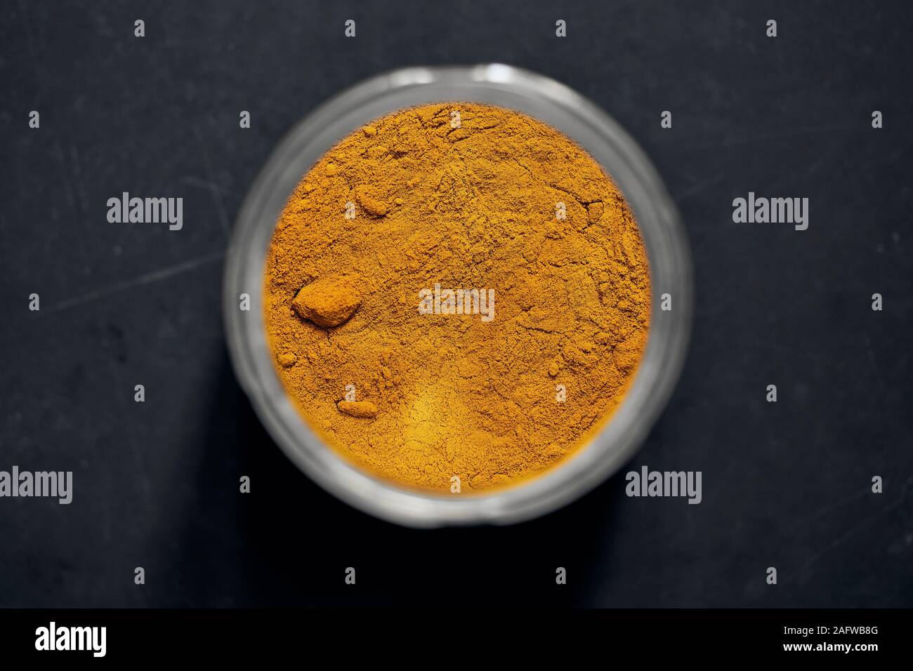 View from above turmeric powder in spice jar Stock Photo - Alamy