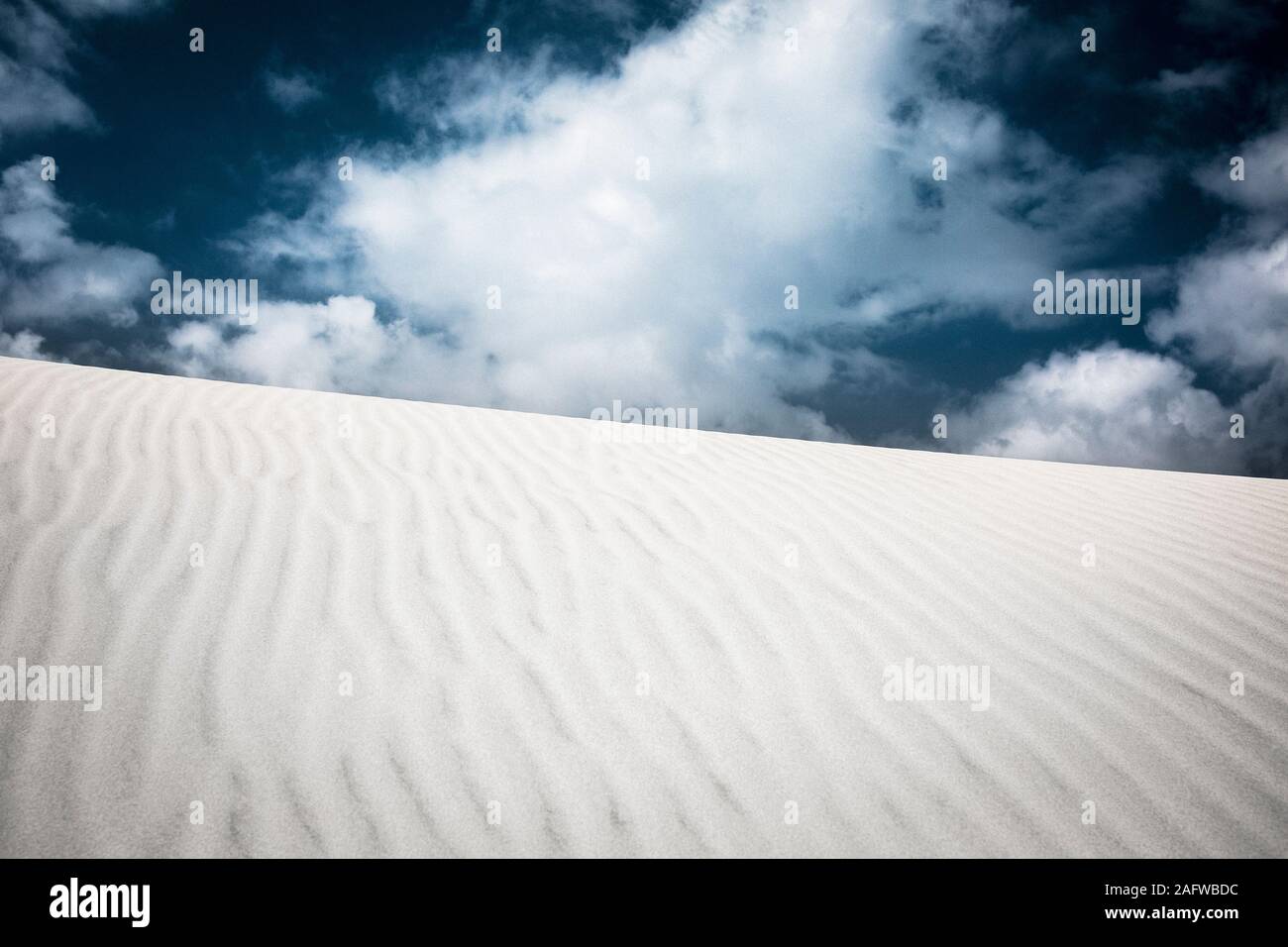 Pattern over sand dune below clouds in sky Stock Photo - Alamy