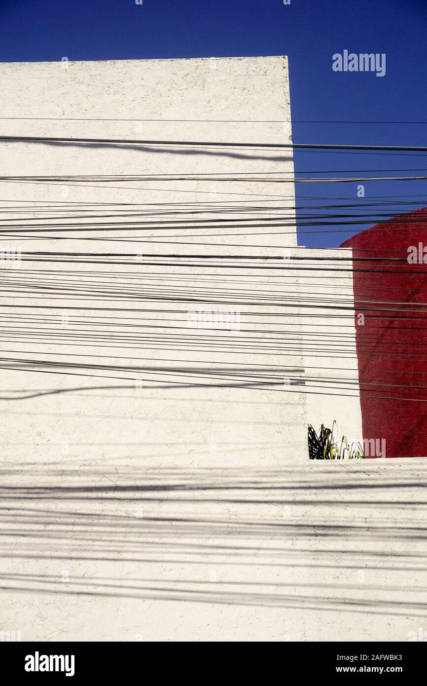 Electrical cables along white building exterior Stock Photo - Alamy