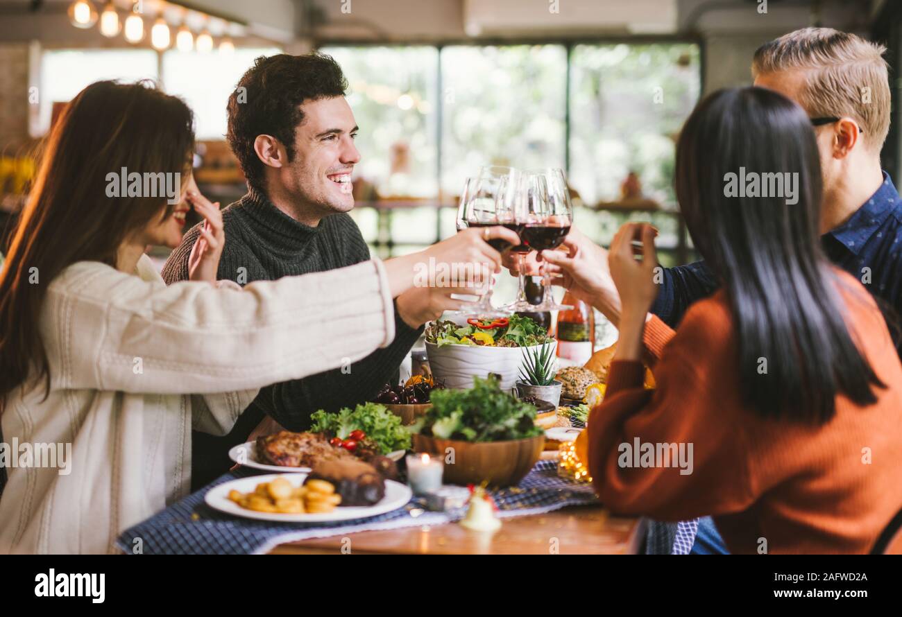 Dinner with friends. Group of young people enjoying dinner together ...