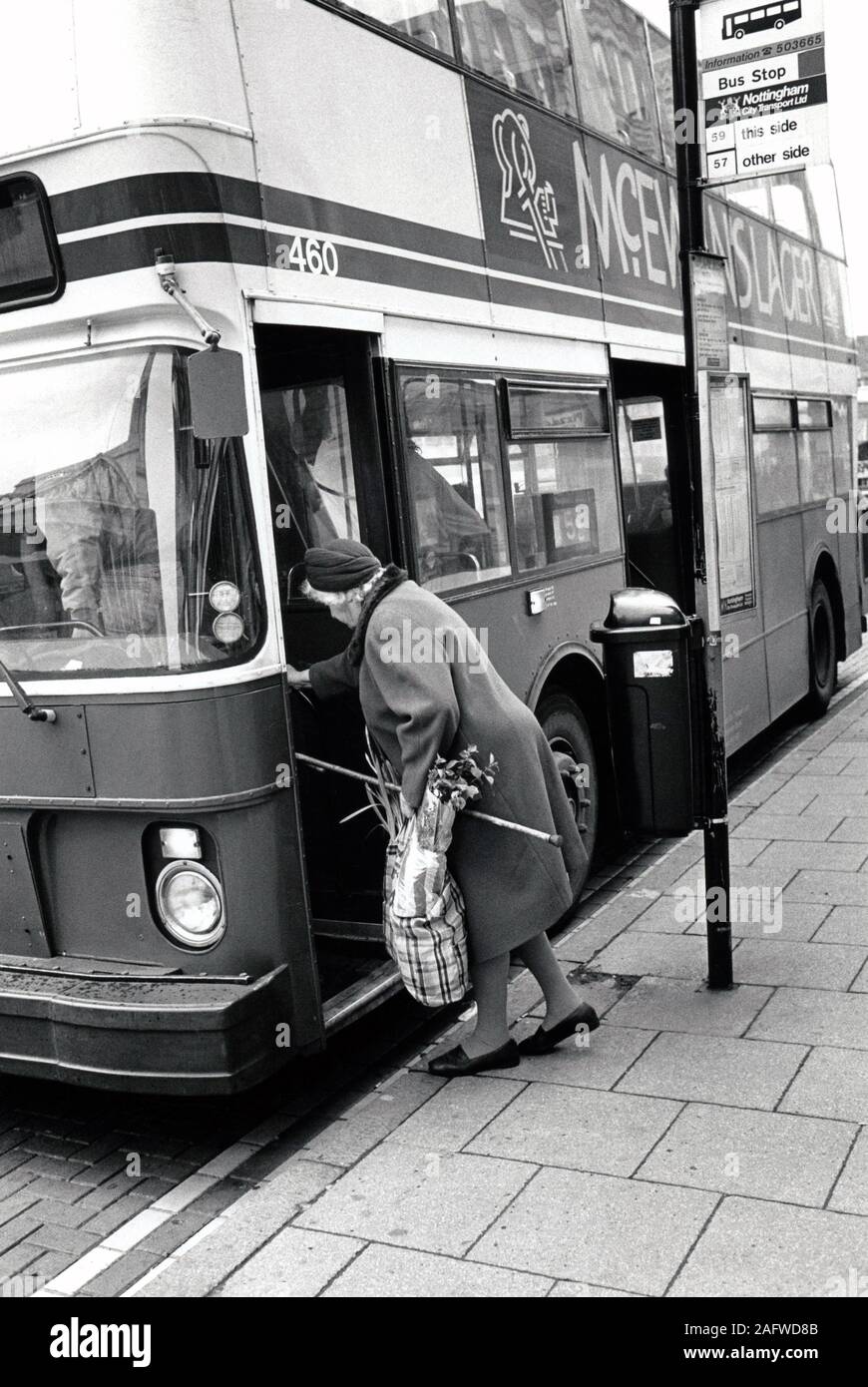 Elderly woman getting on a bus, Nottingham UK 1989 Stock Photo - Alamy