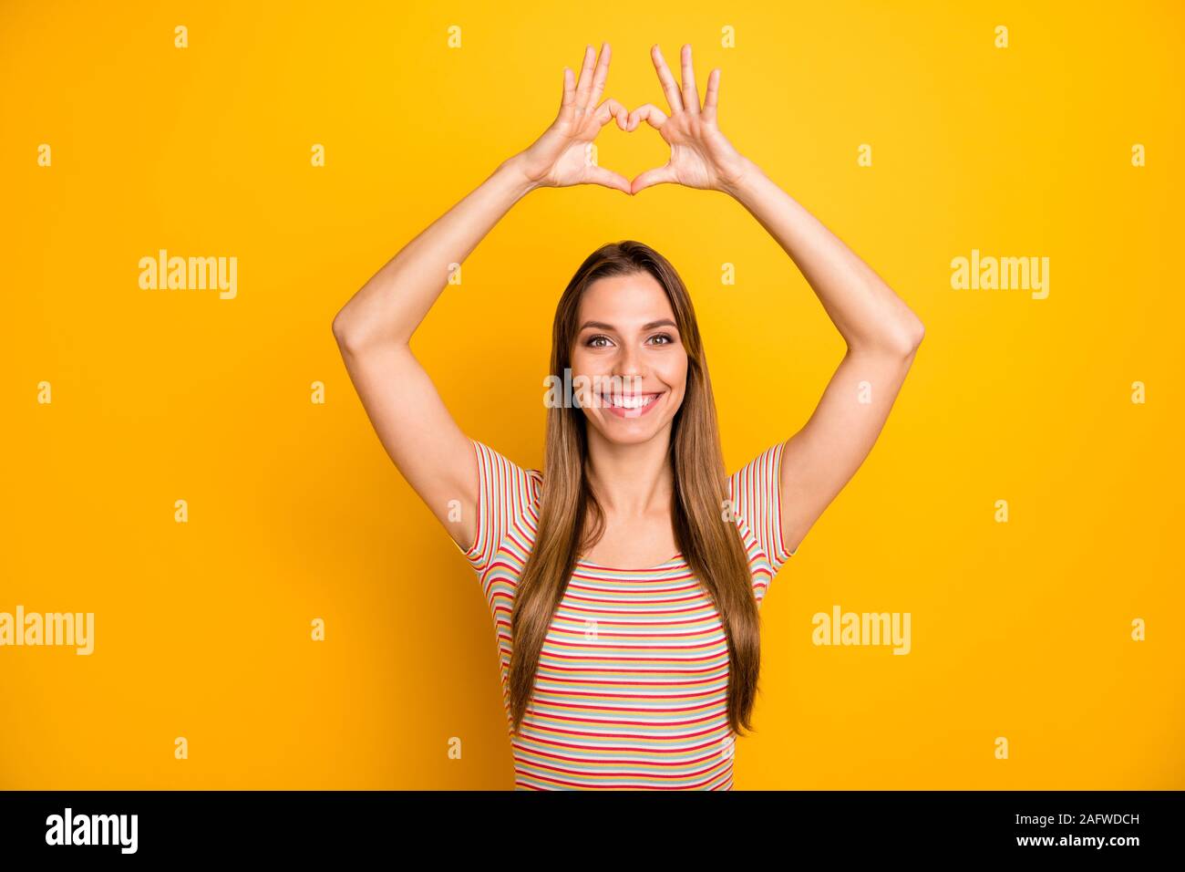 Photo of attractive lady hands making heart figure above head date ...