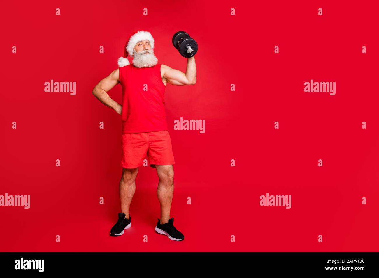 Full size photo of cool santa claus in hat cap holding sport equipment ...