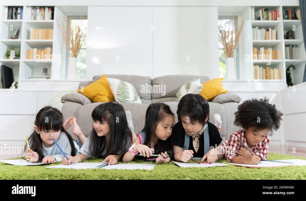Group of little preschool kids drawing paper with color pencils ...