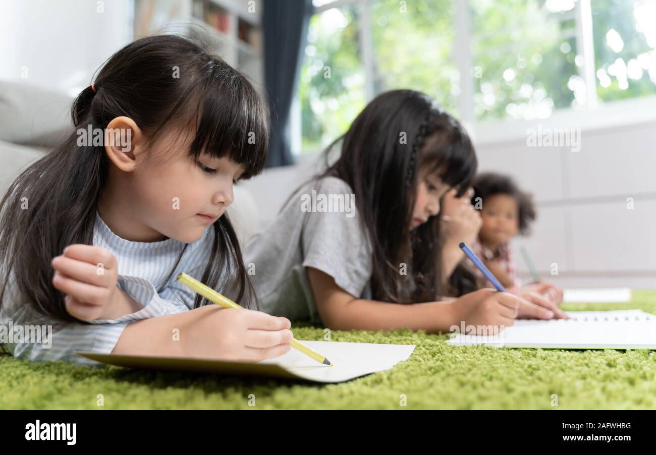 Group of little preschool kids drawing paper with color pencils ...