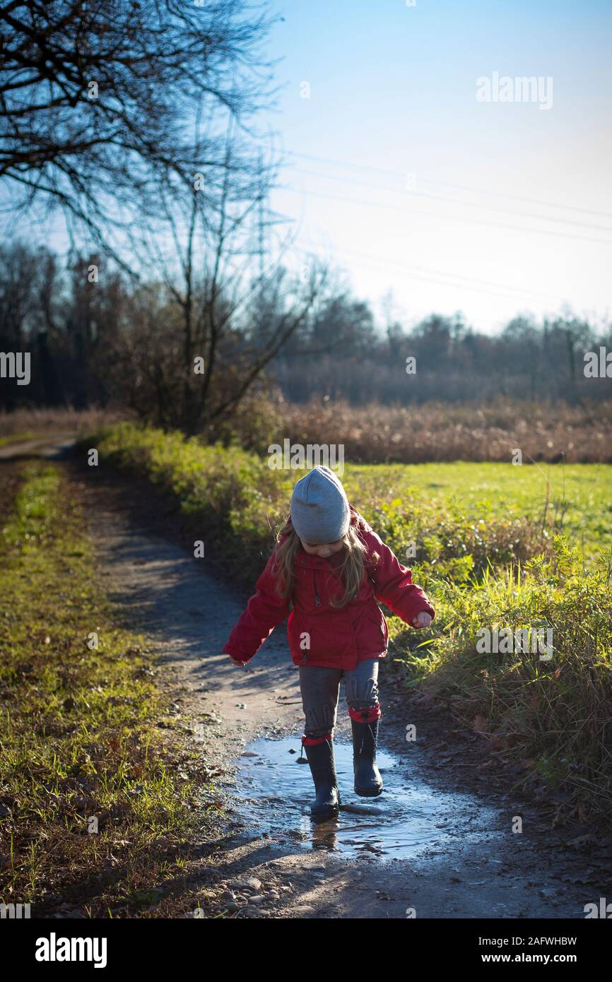 Kid splashing puddle sunny hi-res stock photography and images - Alamy