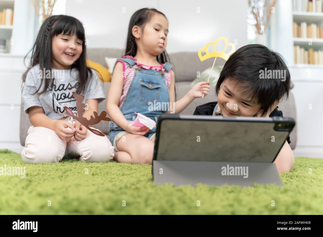 group of little children diversity watching film together on laptop ...
