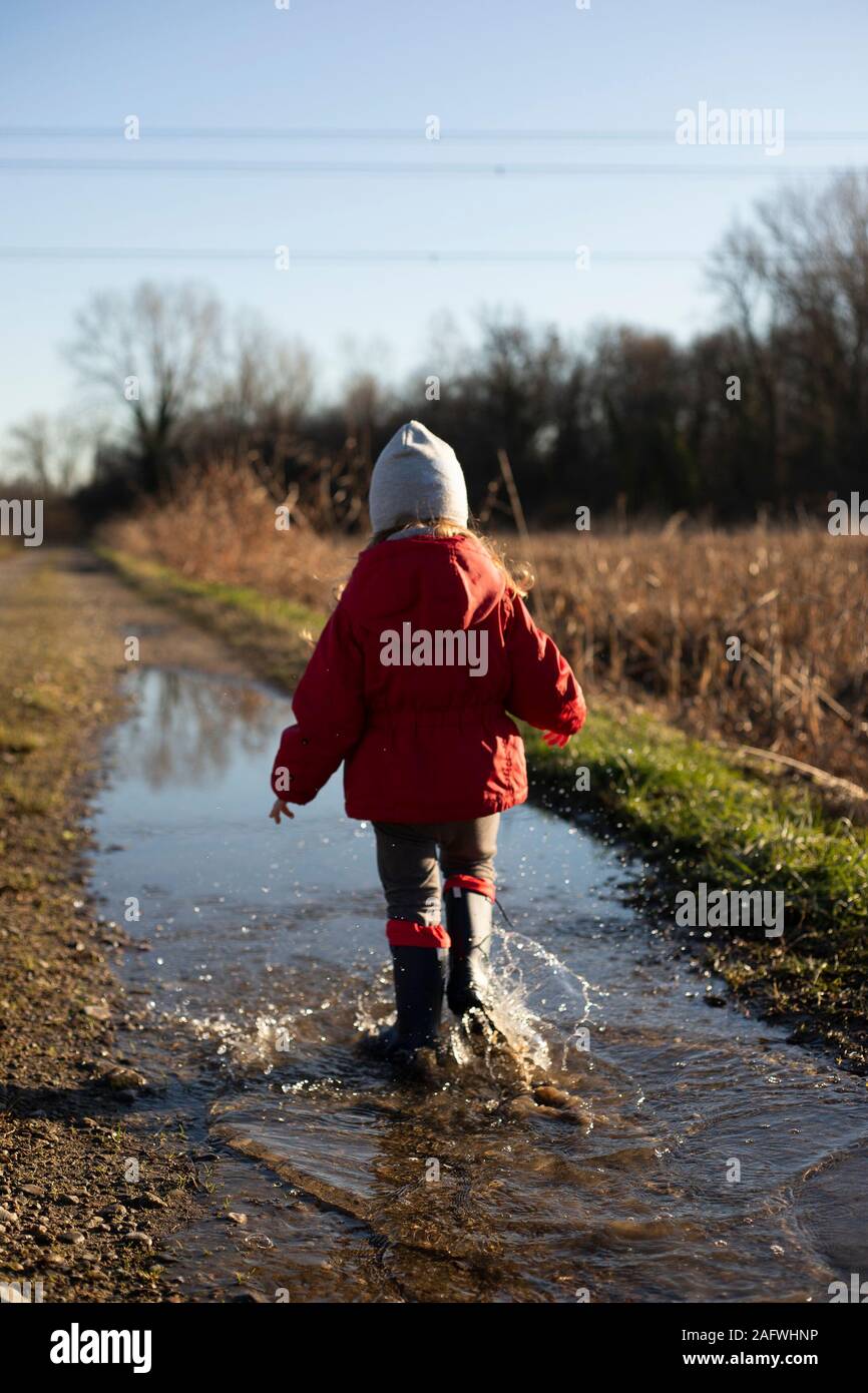 Kid splashing puddle sunny hi-res stock photography and images - Alamy