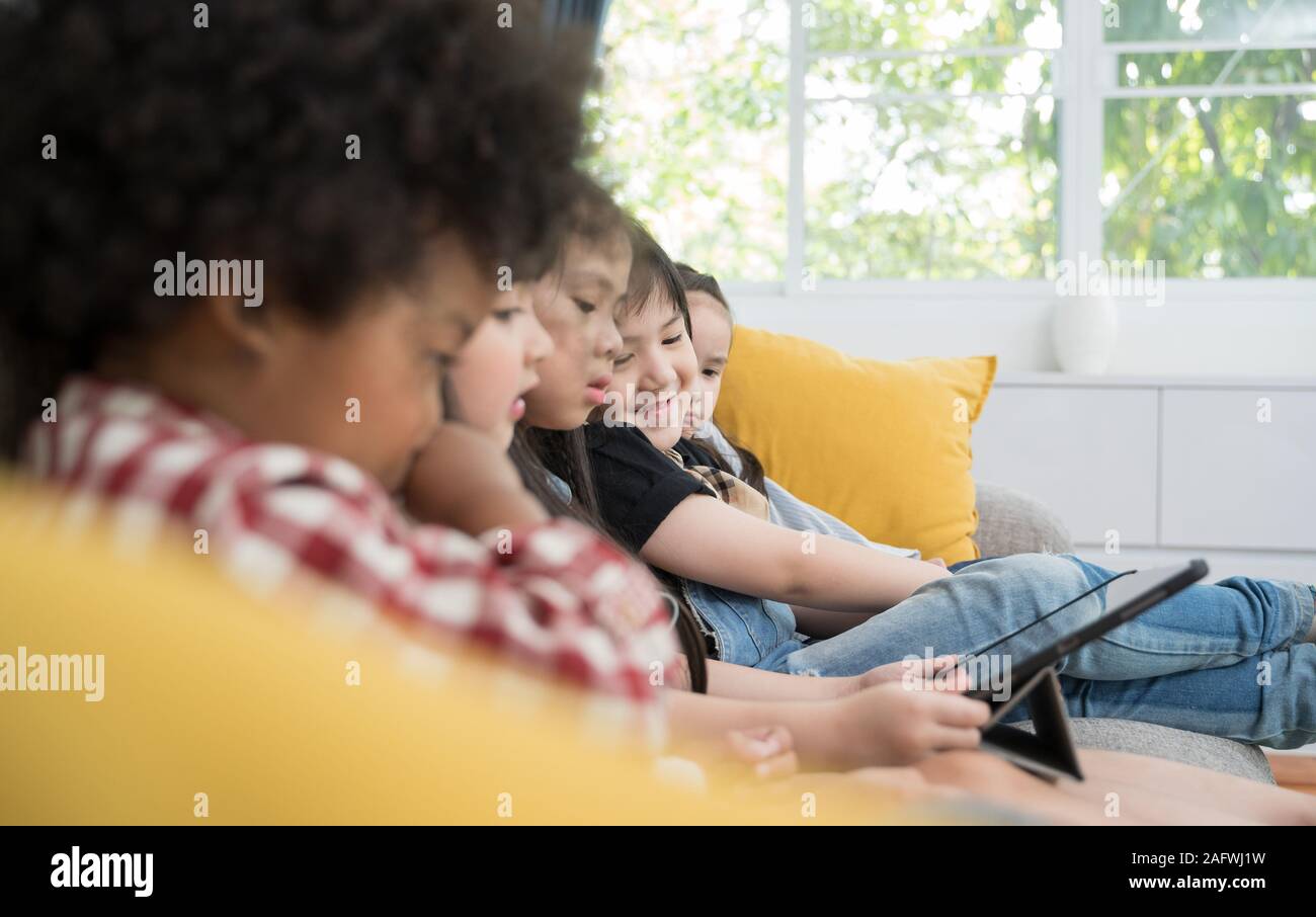 group of little children watching film movie cartoon together on ...