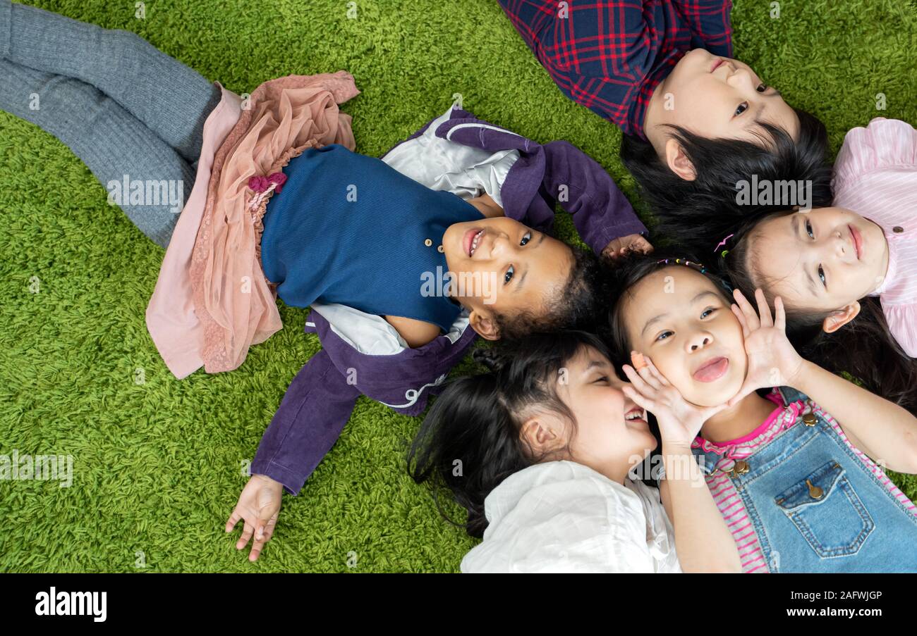 Happy children having fun. kids lay down together Stock Photo - Alamy