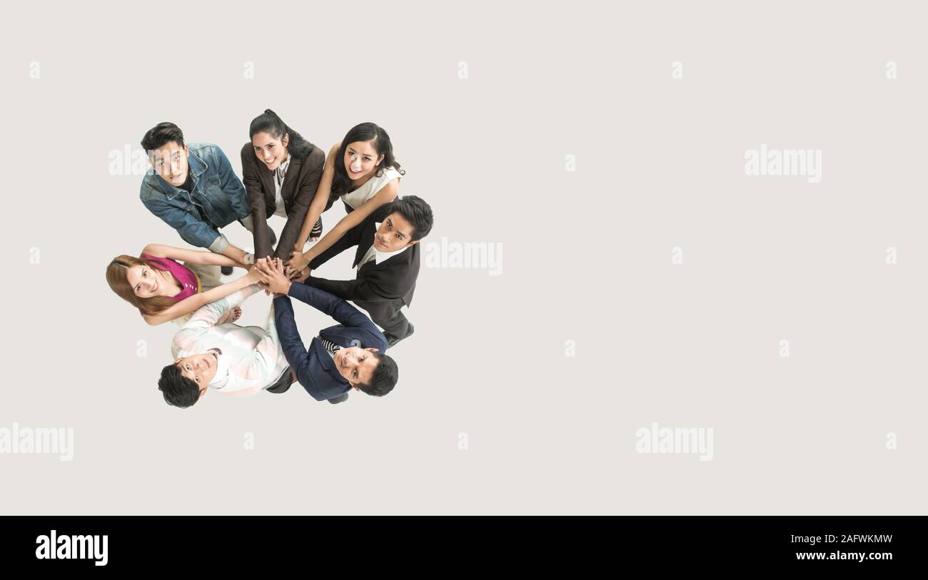 Top view of business people standing with their hands together in a huddle stack hand teamwork ...