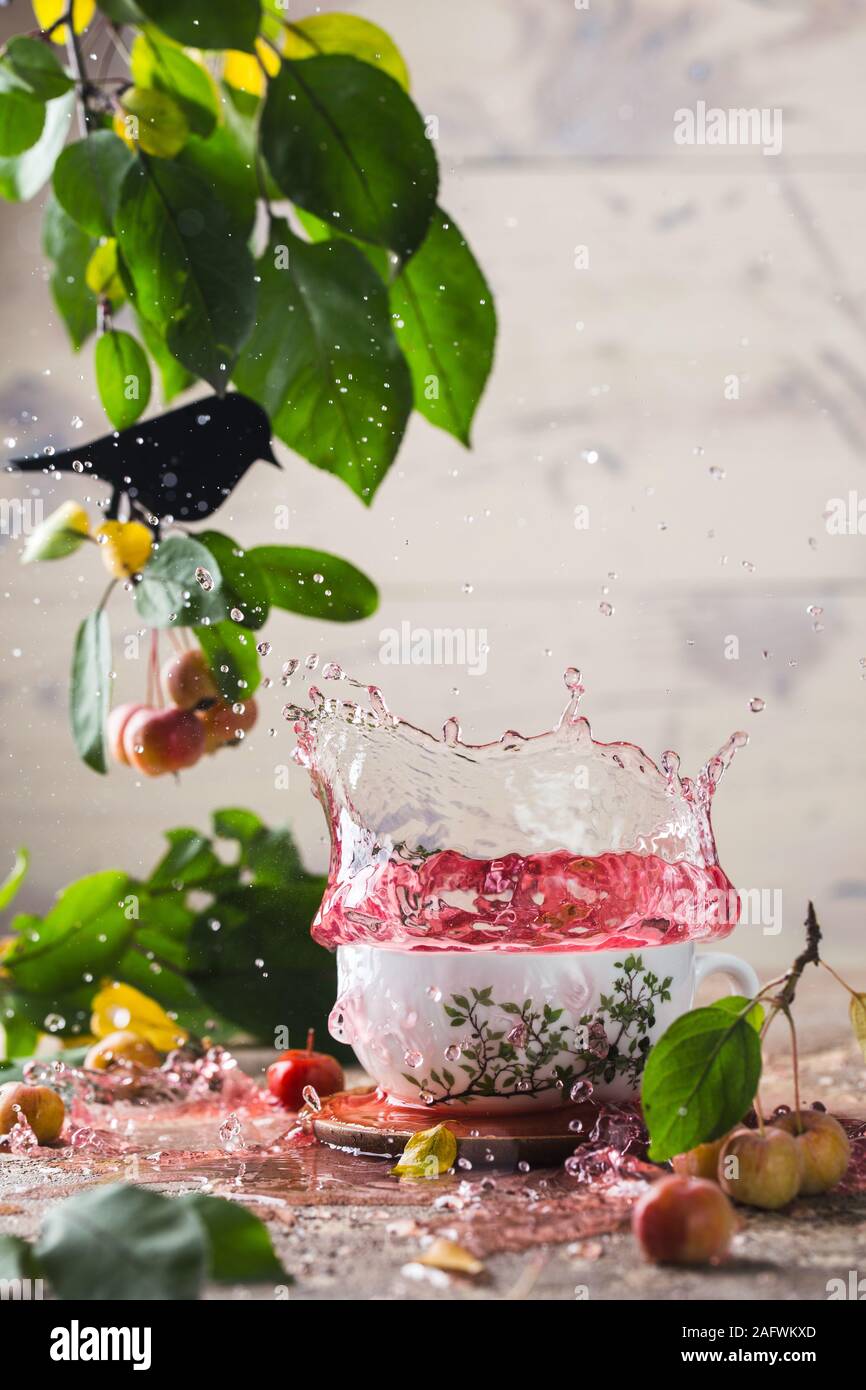 Splash in a porcelain cup of red tea. Tea ceremony. Painted china. In a ...