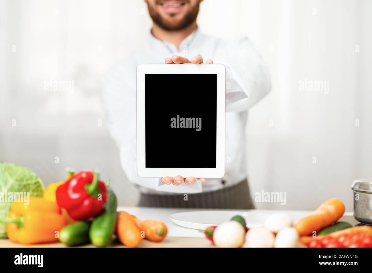 Chef Man Showing Tablet Screen Standing In Restaurant Kitchen, Cropped ...