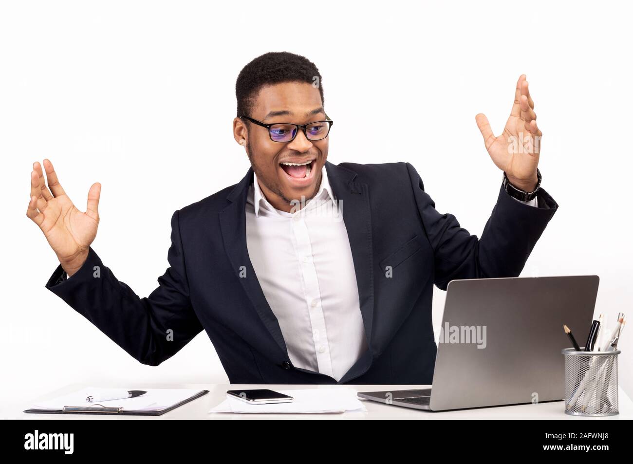 Excited black manager celebrating his victory at work Stock Photo - Alamy