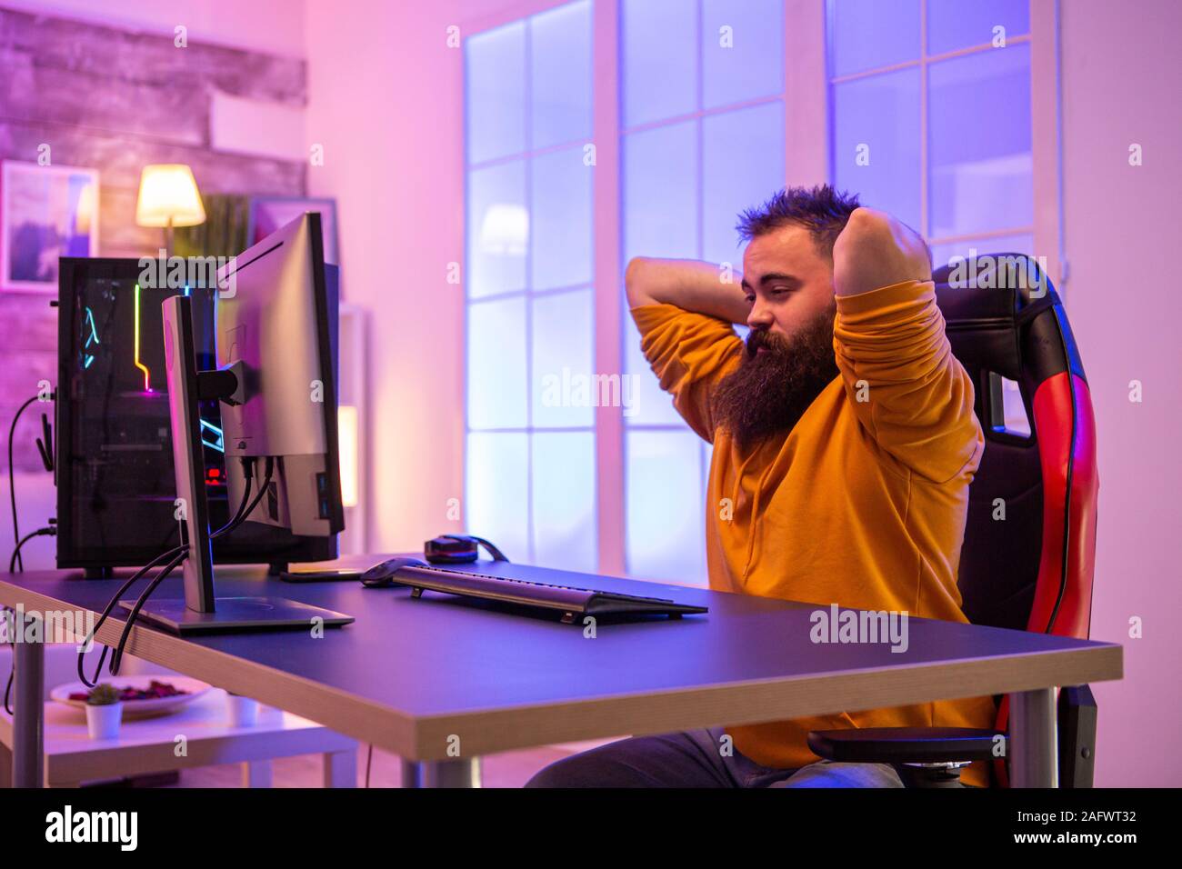 Bearded gamer streaching before a streaming seassion Stock Photo - Alamy