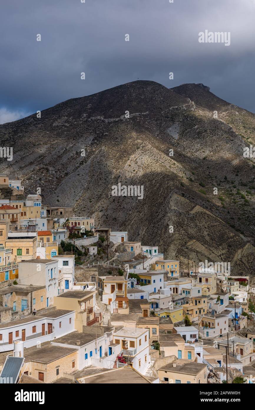 View of a high rocky mountain surrounded by white modern buildings ...