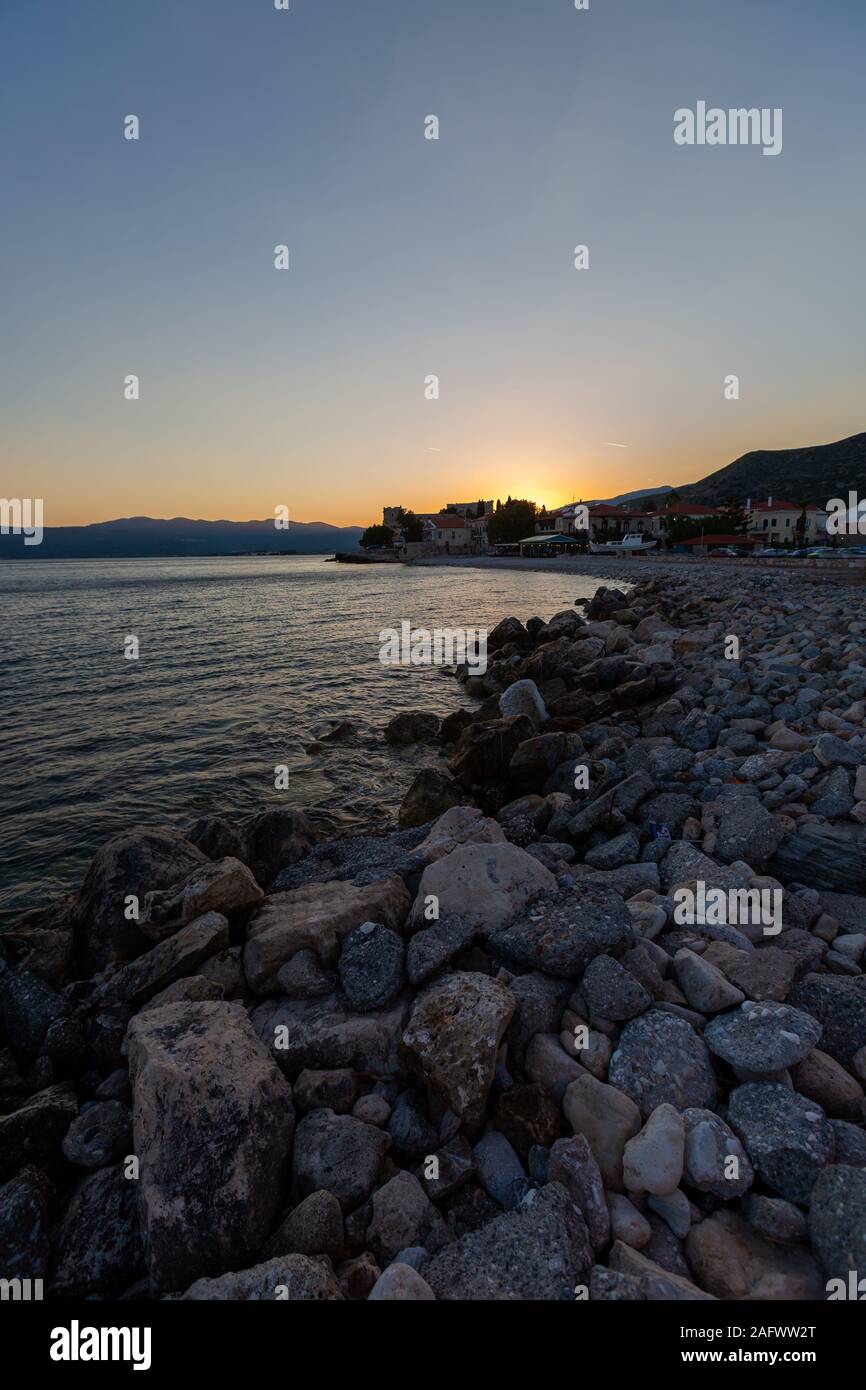 Vertical shot of the rocks on the beach by the ocean captured in Samos ...