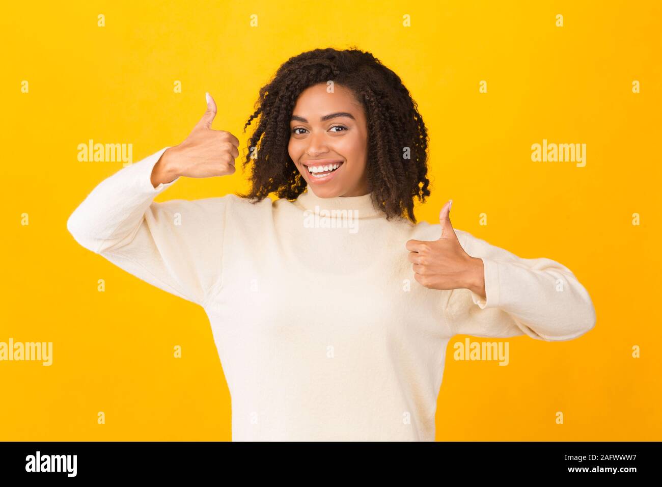 Smiling african american student showing thumbs up Stock Photo - Alamy