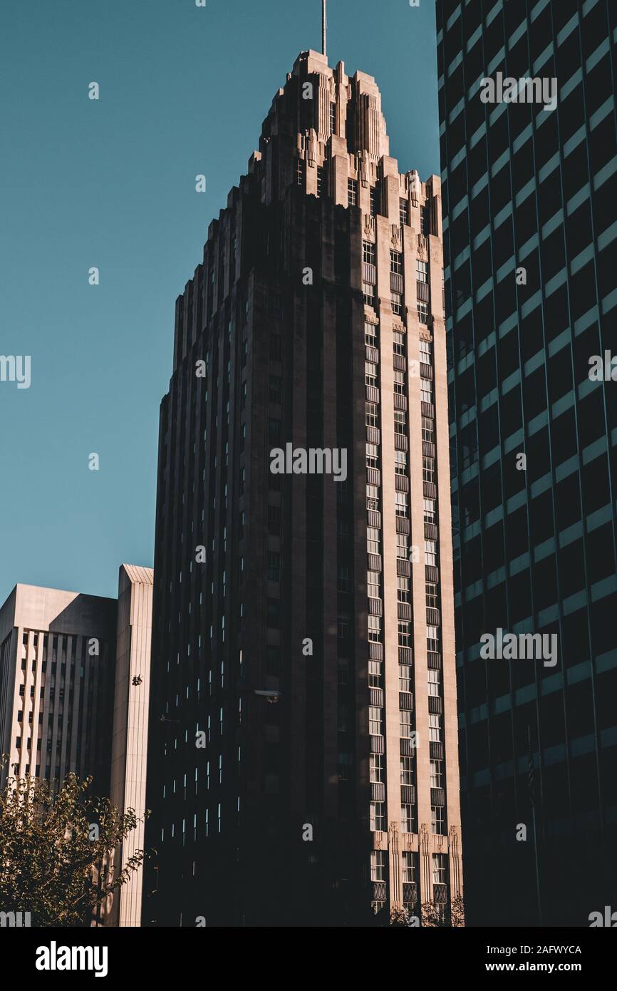 Vertical shot of a modern high rise business building touching the sky ...