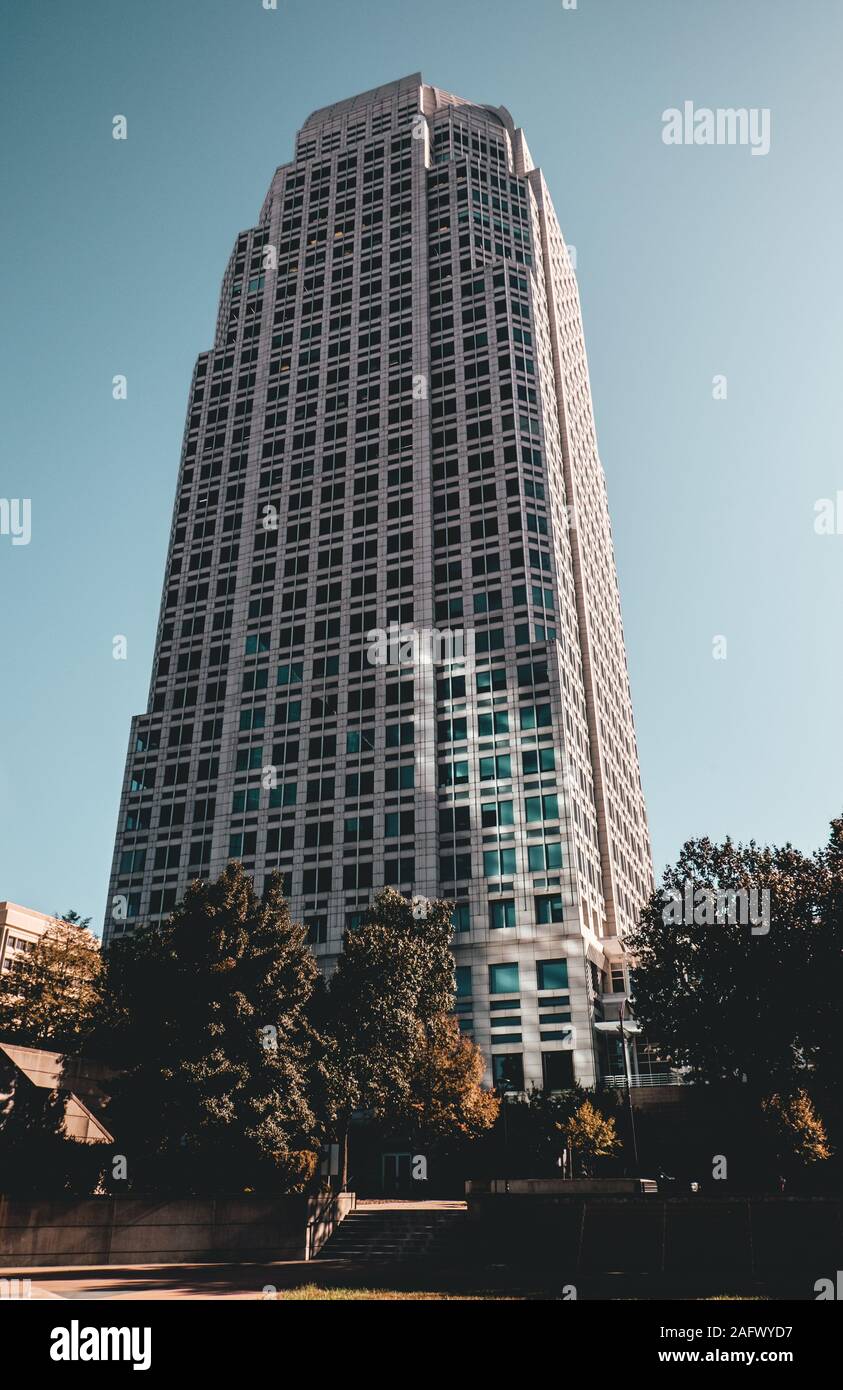 Vertical shot of a modern high rise business building touching the sky ...