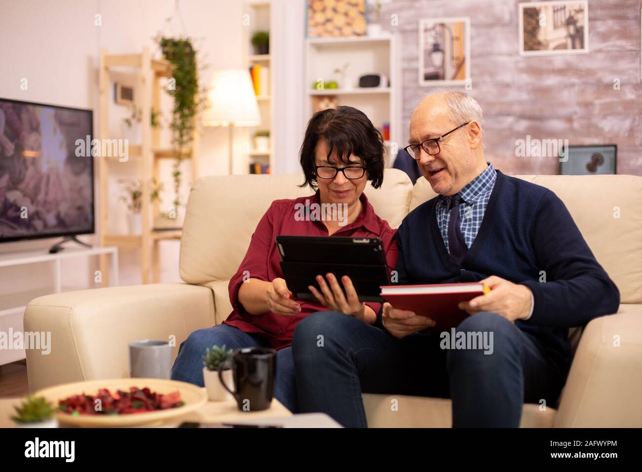 Beautiful old couple using a digital tablet to chat with their family ...