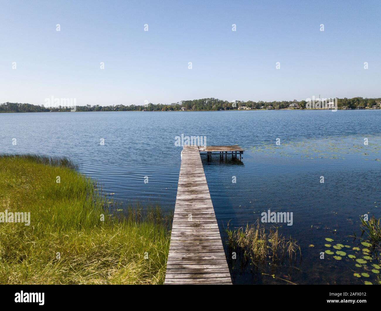 Wooden pathway over the water with a blue sky in the background Stock ...