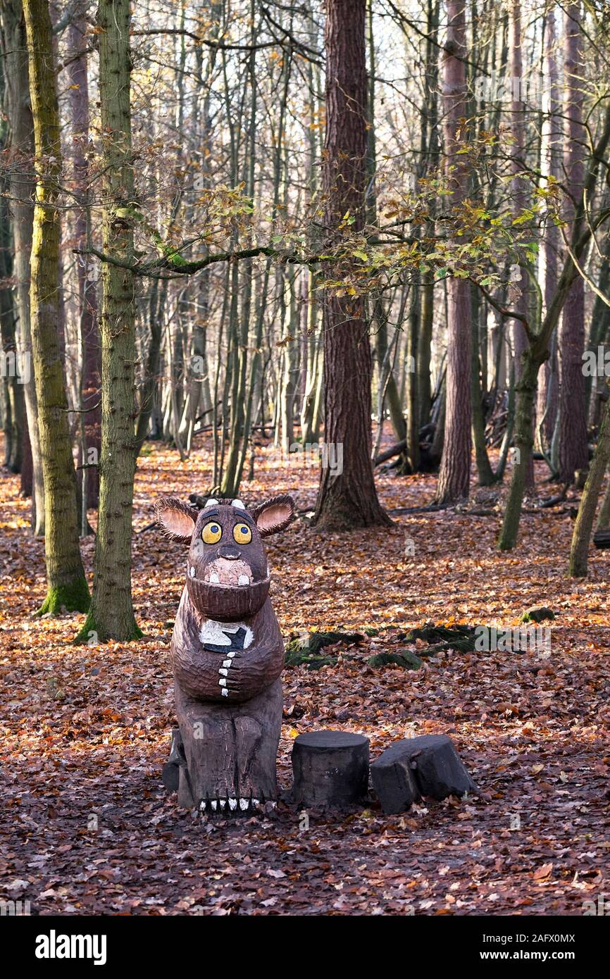 A wooden carved statue of a Baby Gruffalo in an autumnal Thorndon Park ...