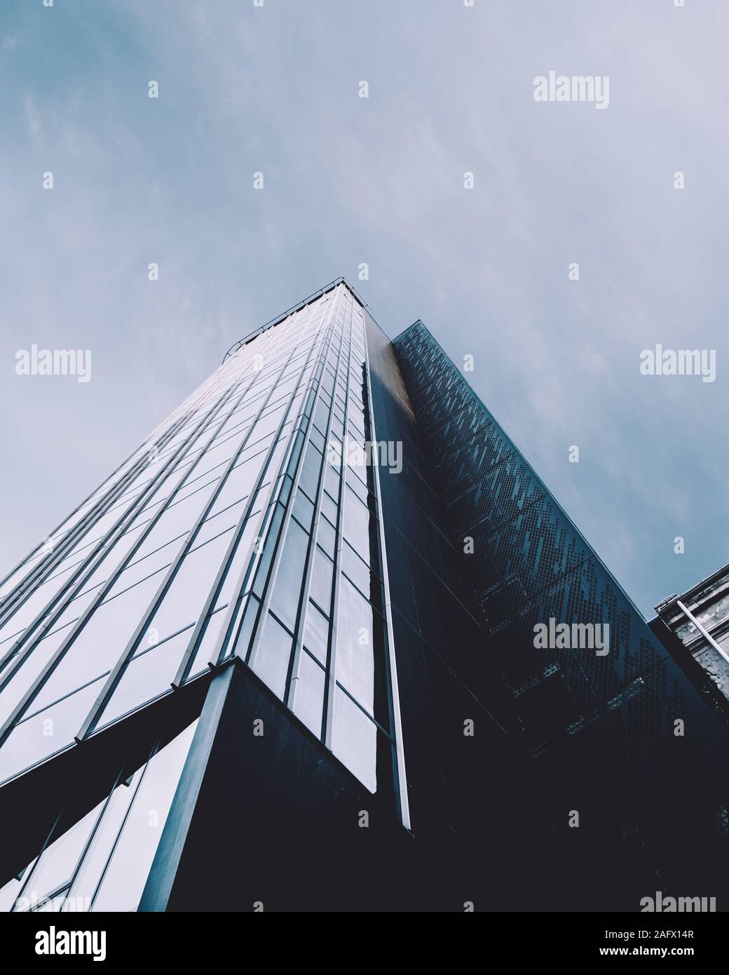 Vertical low angle shot of a high rise building in a glass facade Stock ...