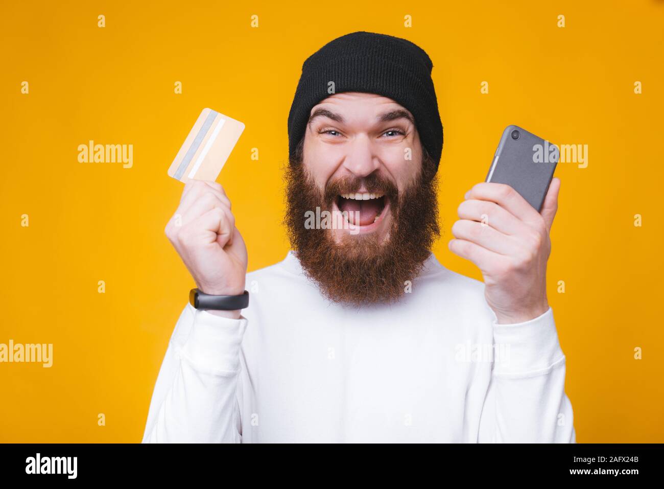 Amazed man just received his new credit card Stock Photo - Alamy