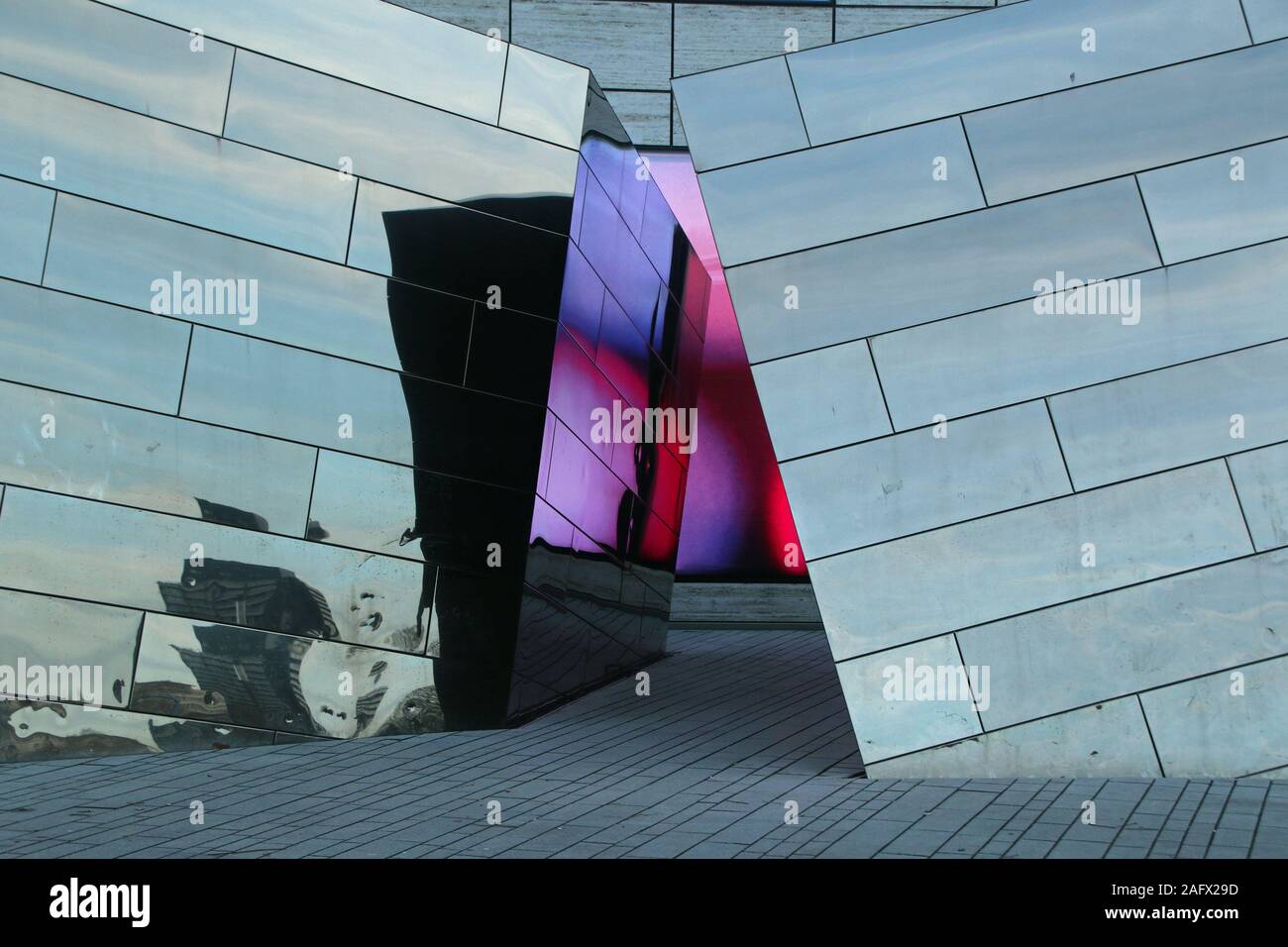 Modern architectural structure in a glass facade with the reflection of ...