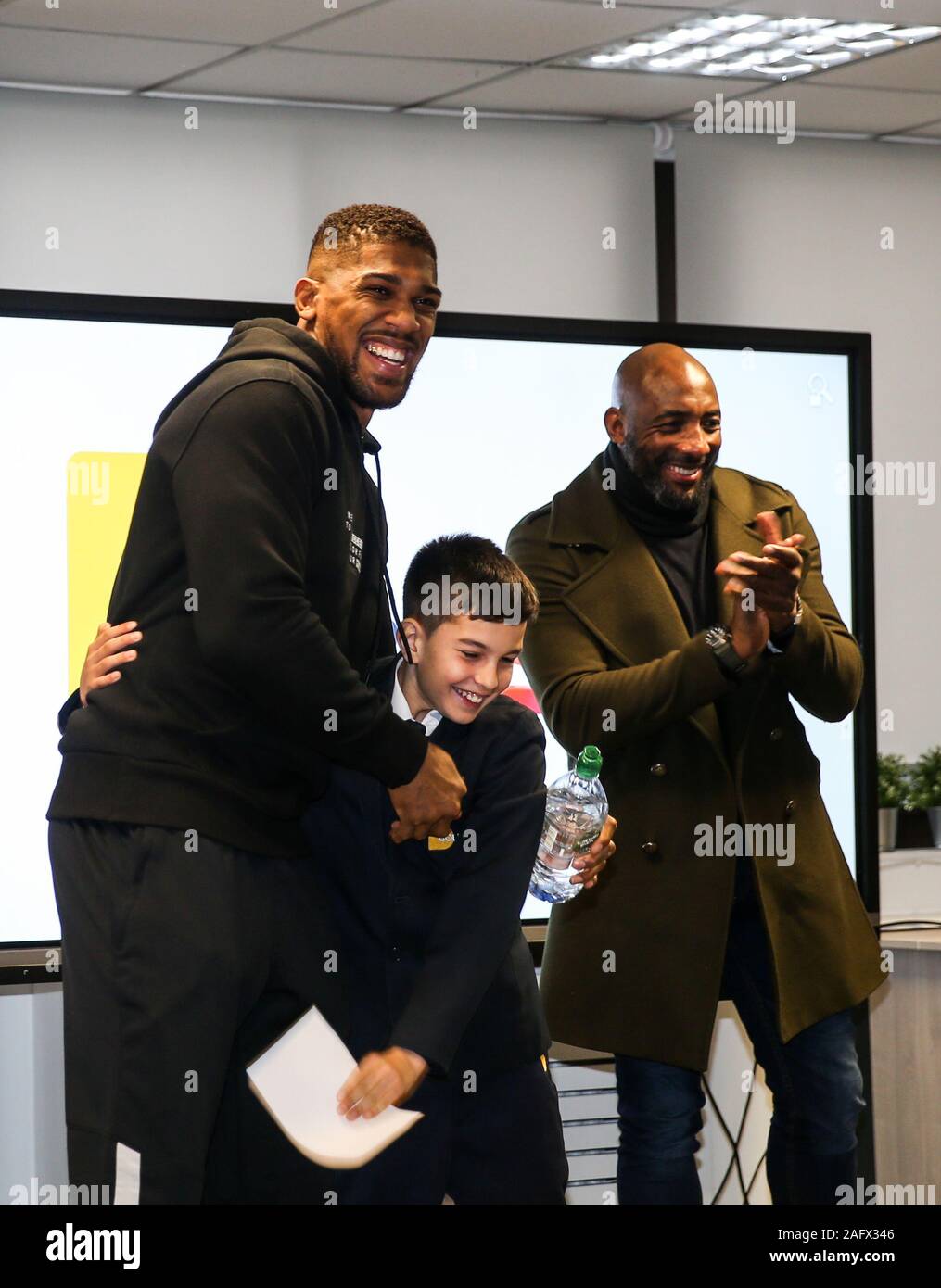 Anthony Joshua (left) and Johnny Nelson with Sliver Award winner Bailey ...