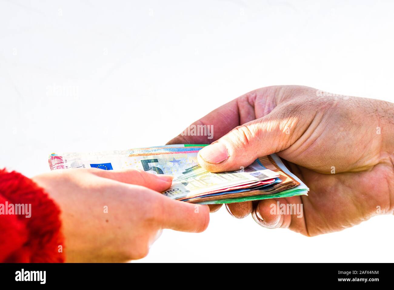 Hand giving stack of money isolated, hard worked hand taking euro money ...