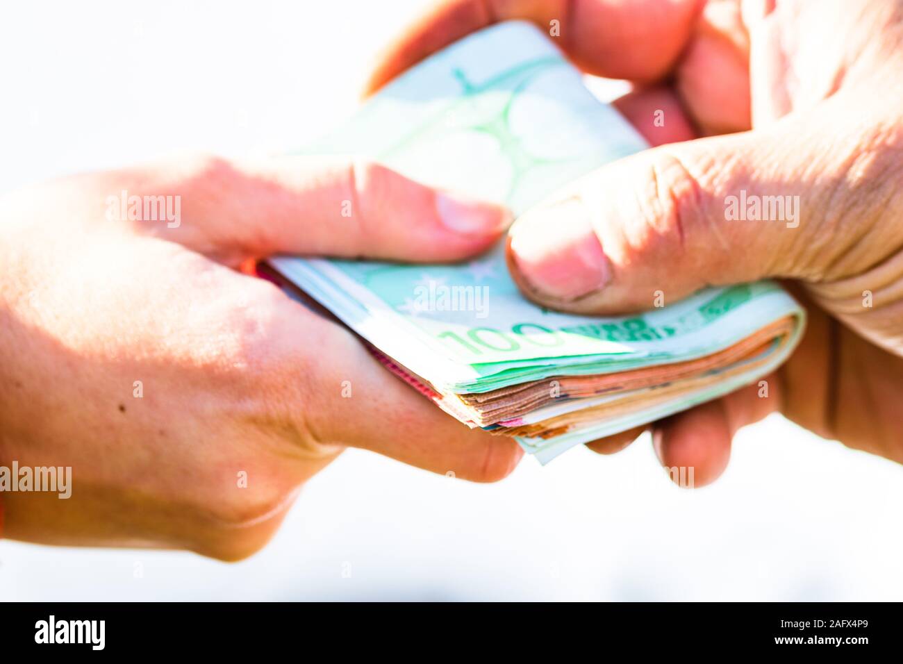 Hand giving stack of money isolated, hard worked hand taking euro money ...