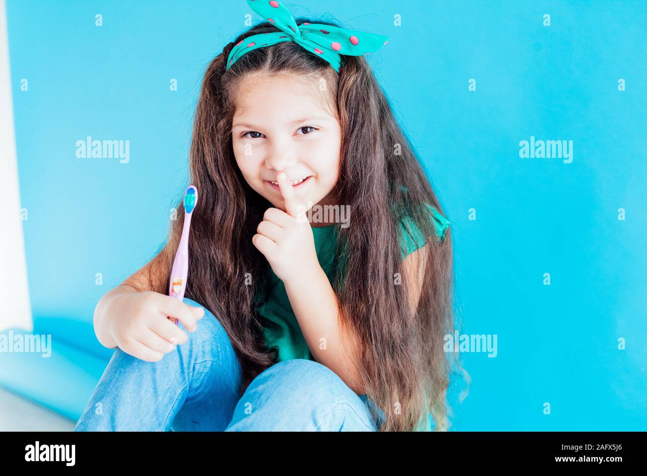 little girl with no teeth with a toothbrush in dentistry Stock Photo ...