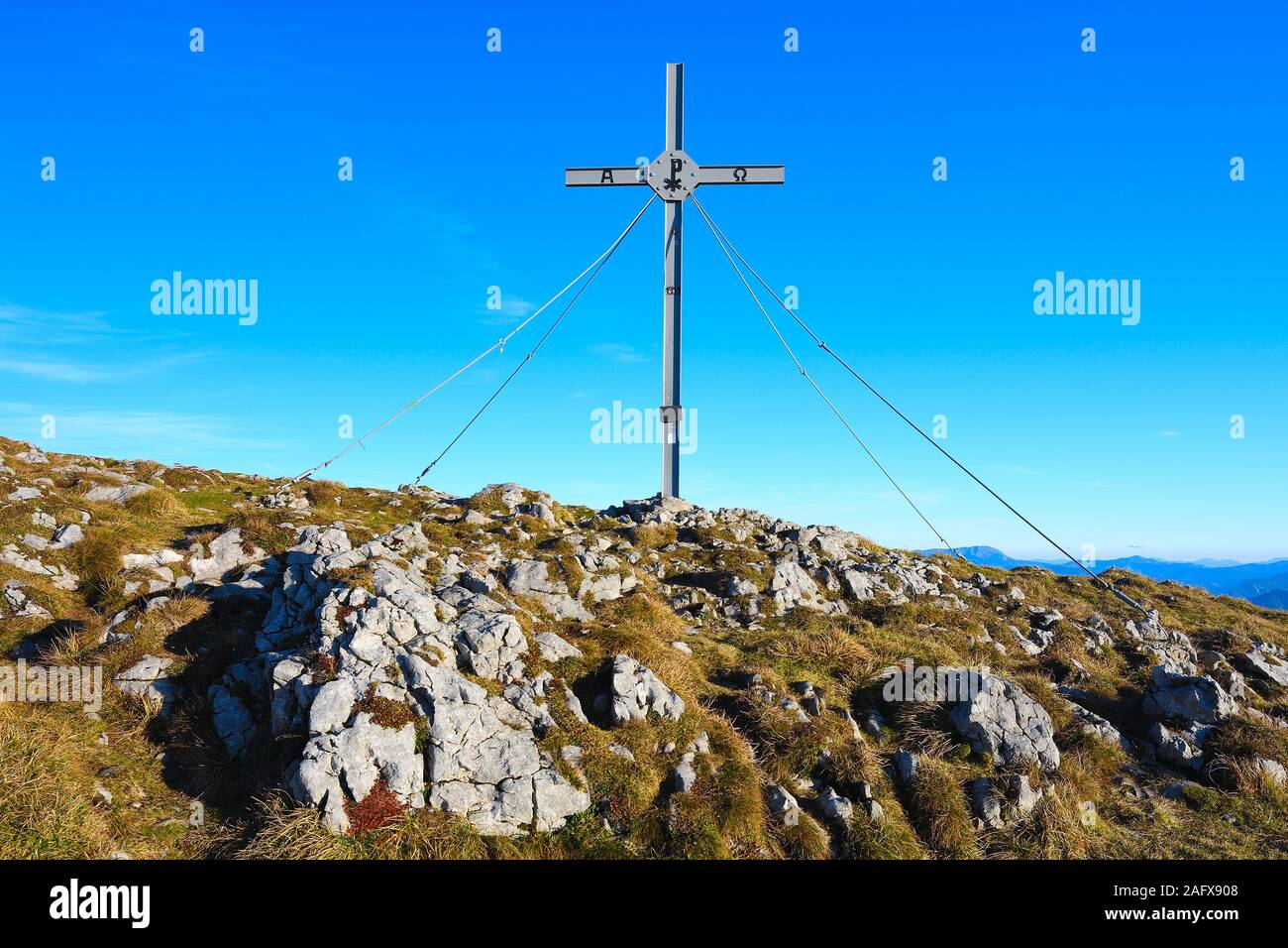 Praying summit cross on high rocky mountain. Steel artistic crucifix on ...